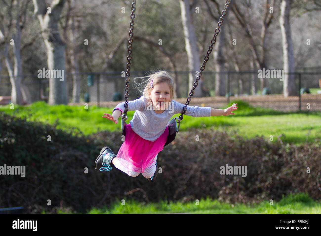 A Swinging Day At The Park Stock Photo - Alamy