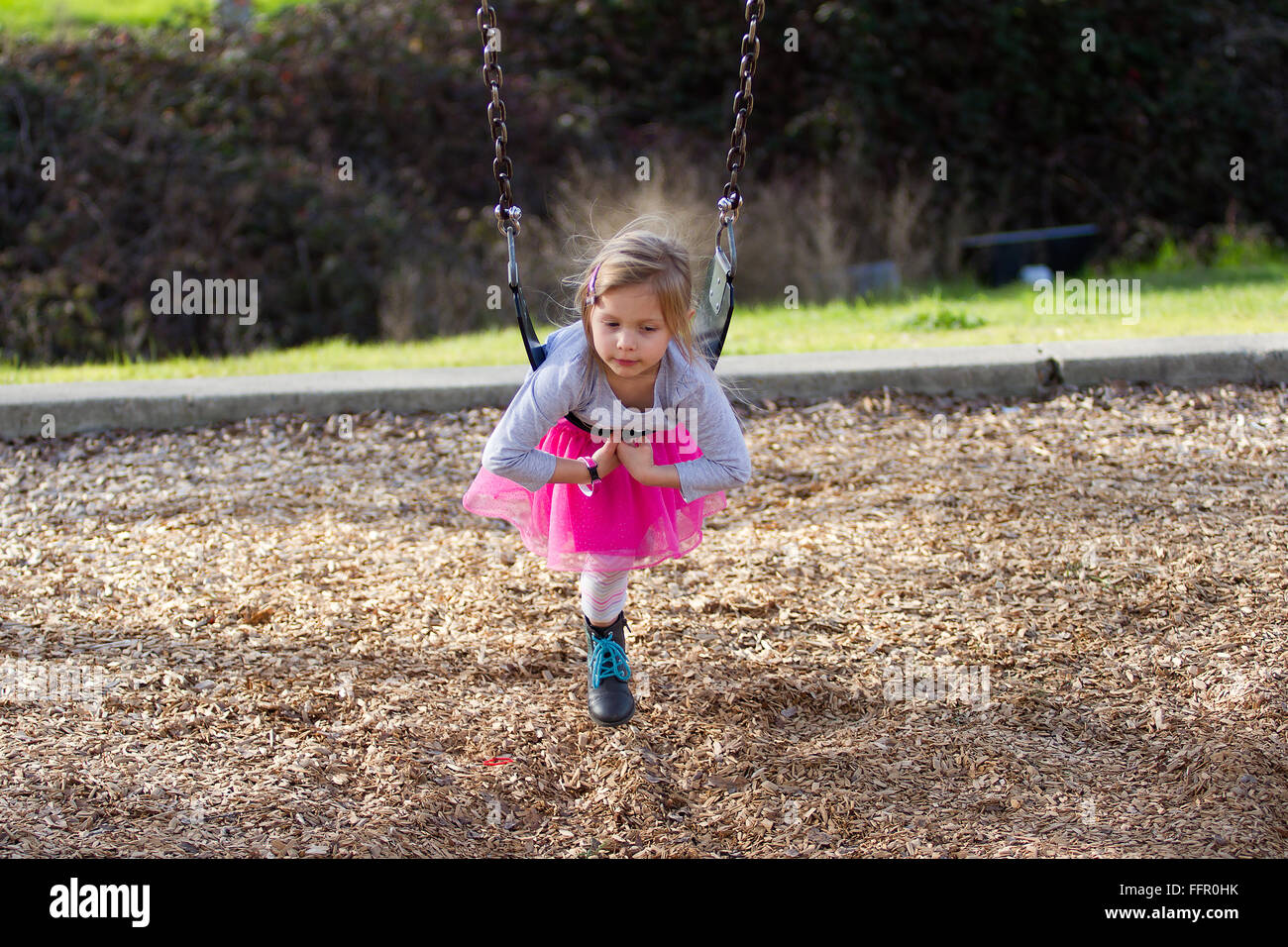 A Swinging Day At The Park Stock Photo - Alamy
