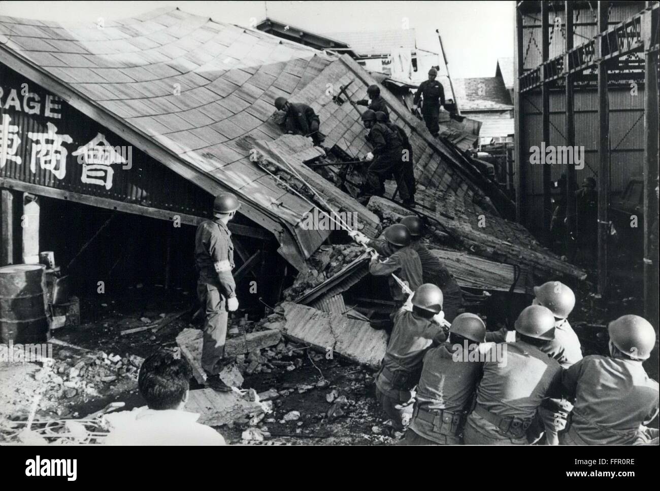 1976 - Japanese Self Defense Force men haul a collapsed wall form the ...
