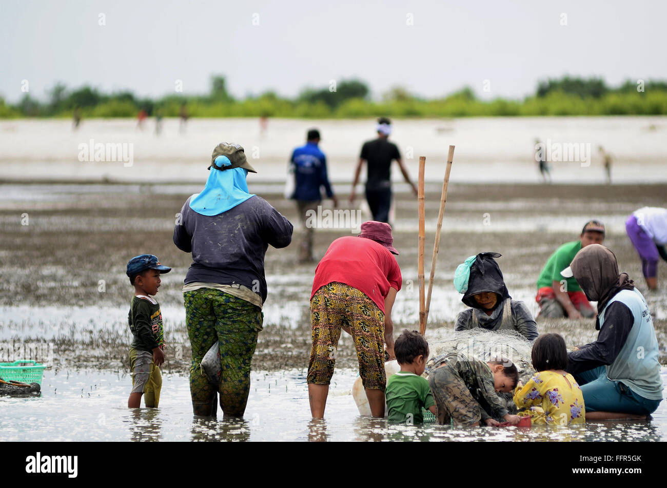 Of people looking for shells on the beach batu bara, North Sumatra ...