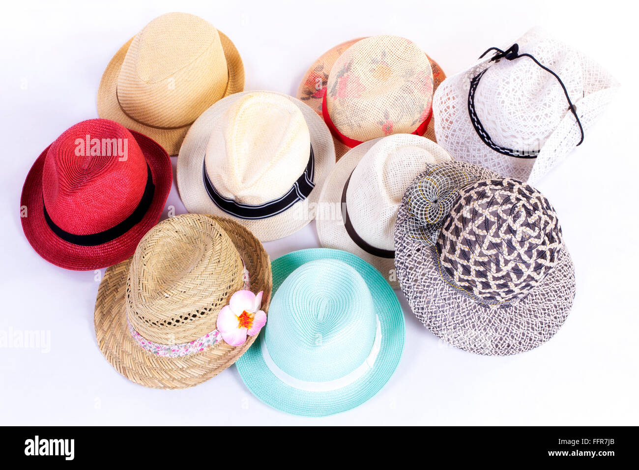 various hats of different colors grouped together on a white background ...