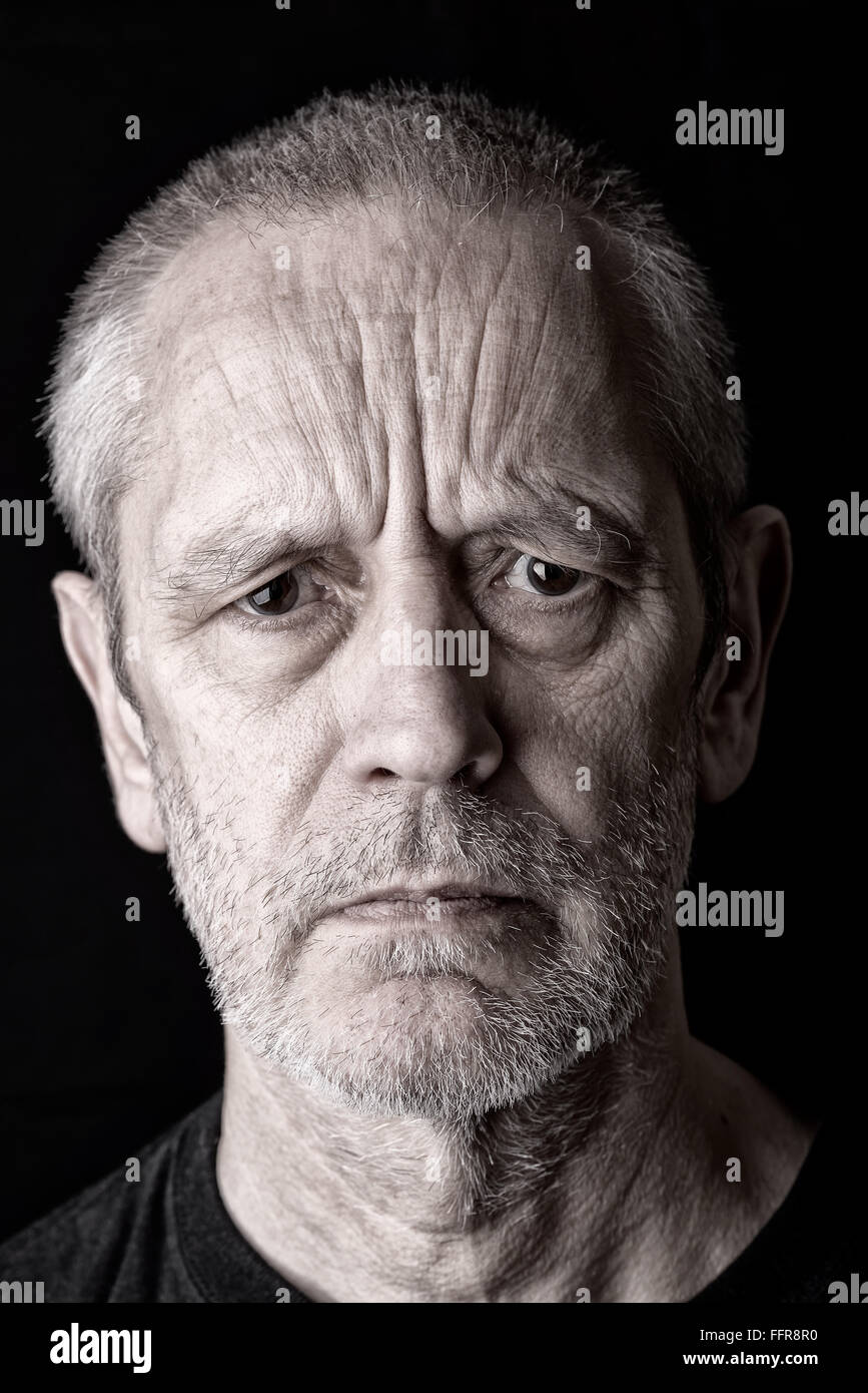 Portrait of a serious and angry man with a penetrating gaze and fury in ...