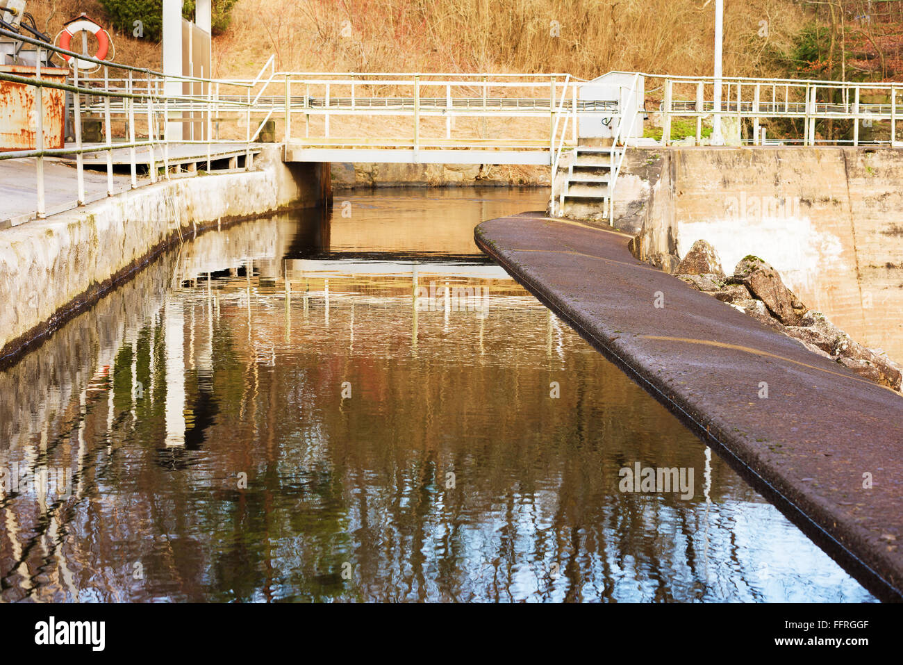 A small bridge spanning over the small hydroelectric dam in Djupafors ...