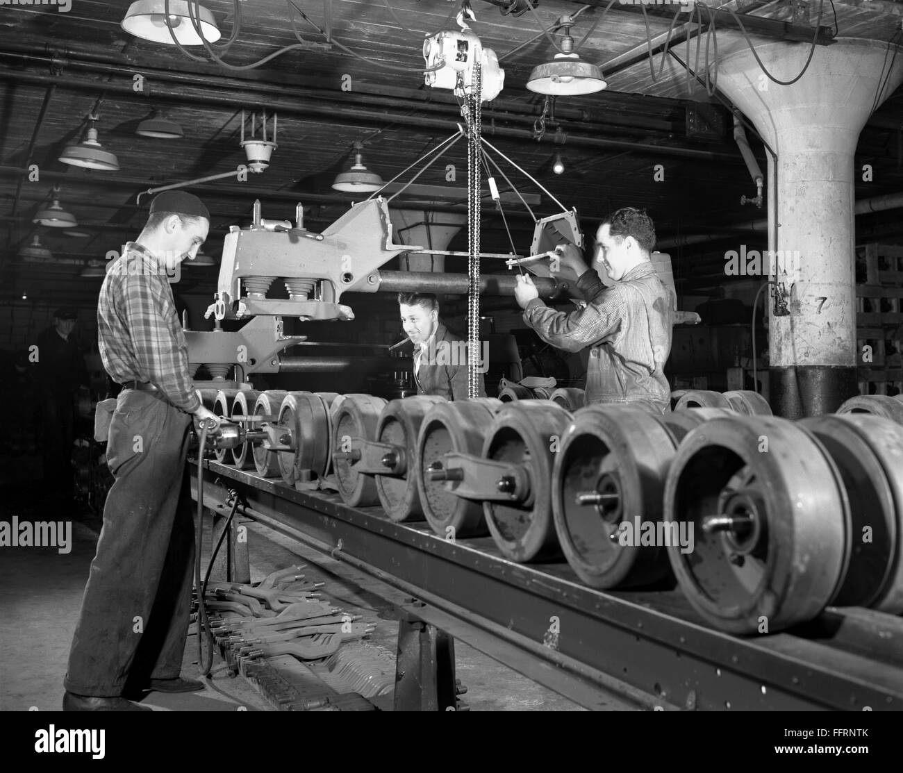HALF-TRACK FACTORY, 1941. /nMen working on an assembly line to ...