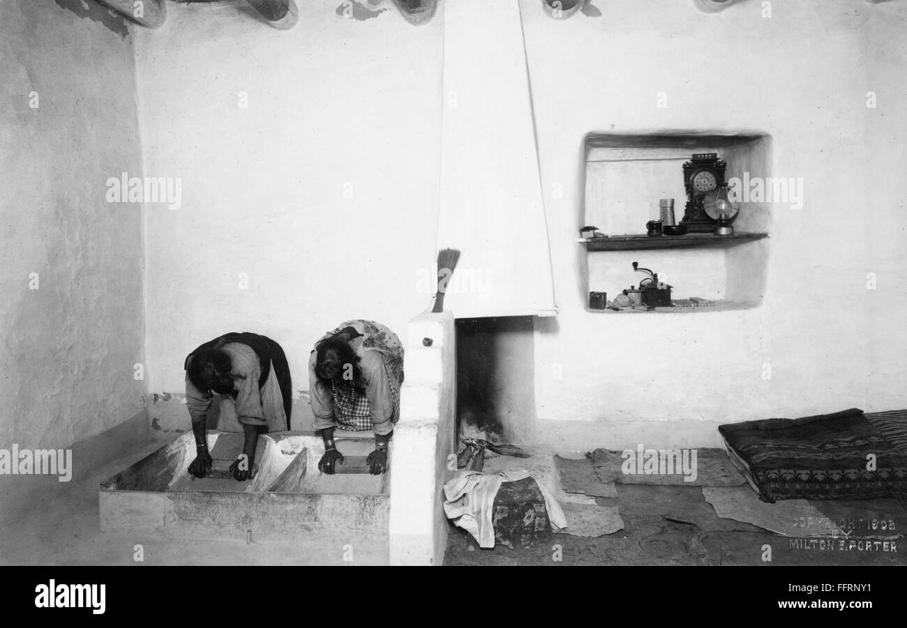 GRINDING CORN, c1908. /nTwo Native American women grinding corn in a ...
