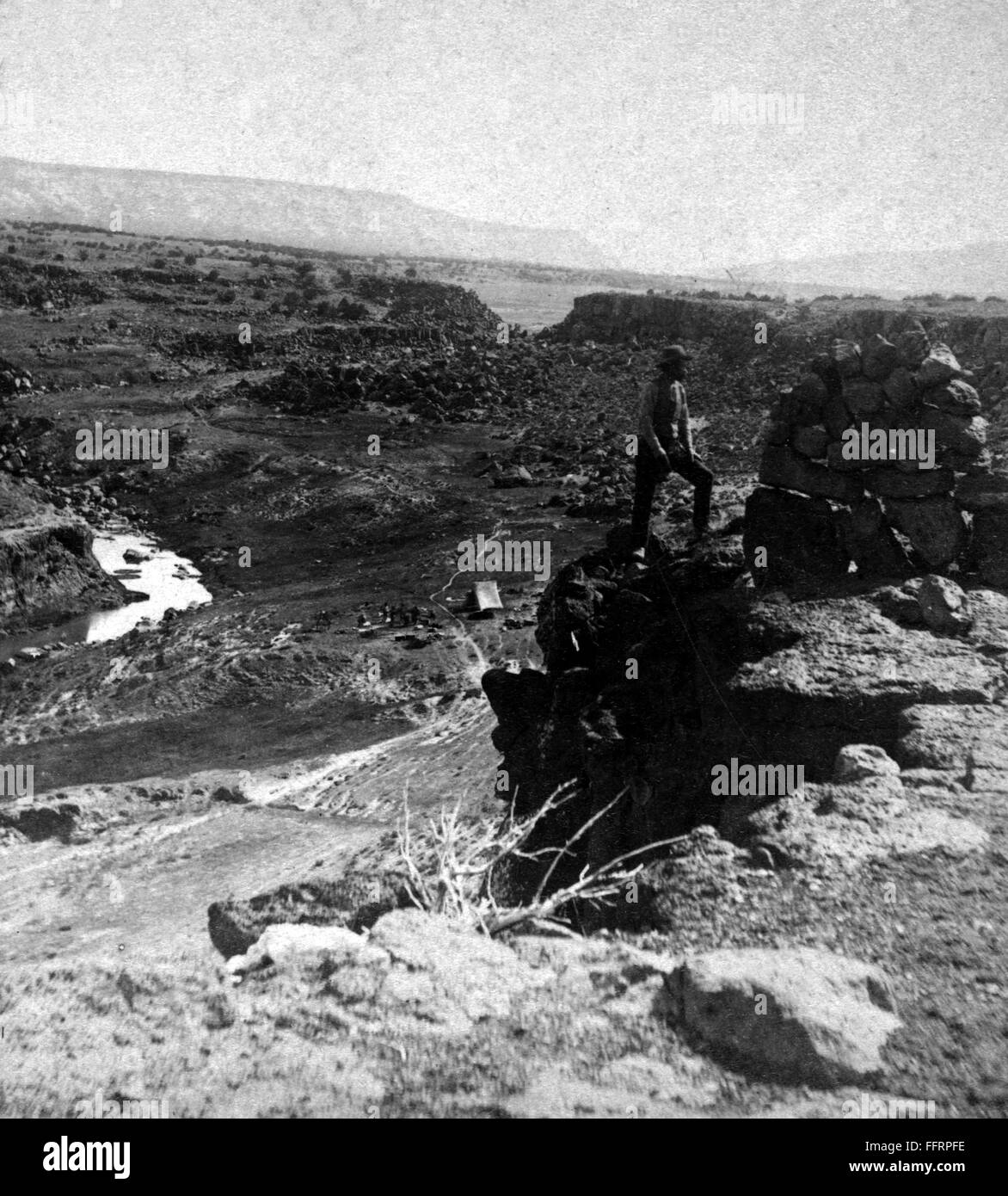 NEW MEXICO: CANYON, 1873. /nA man standing on the edge of a cliff at ...