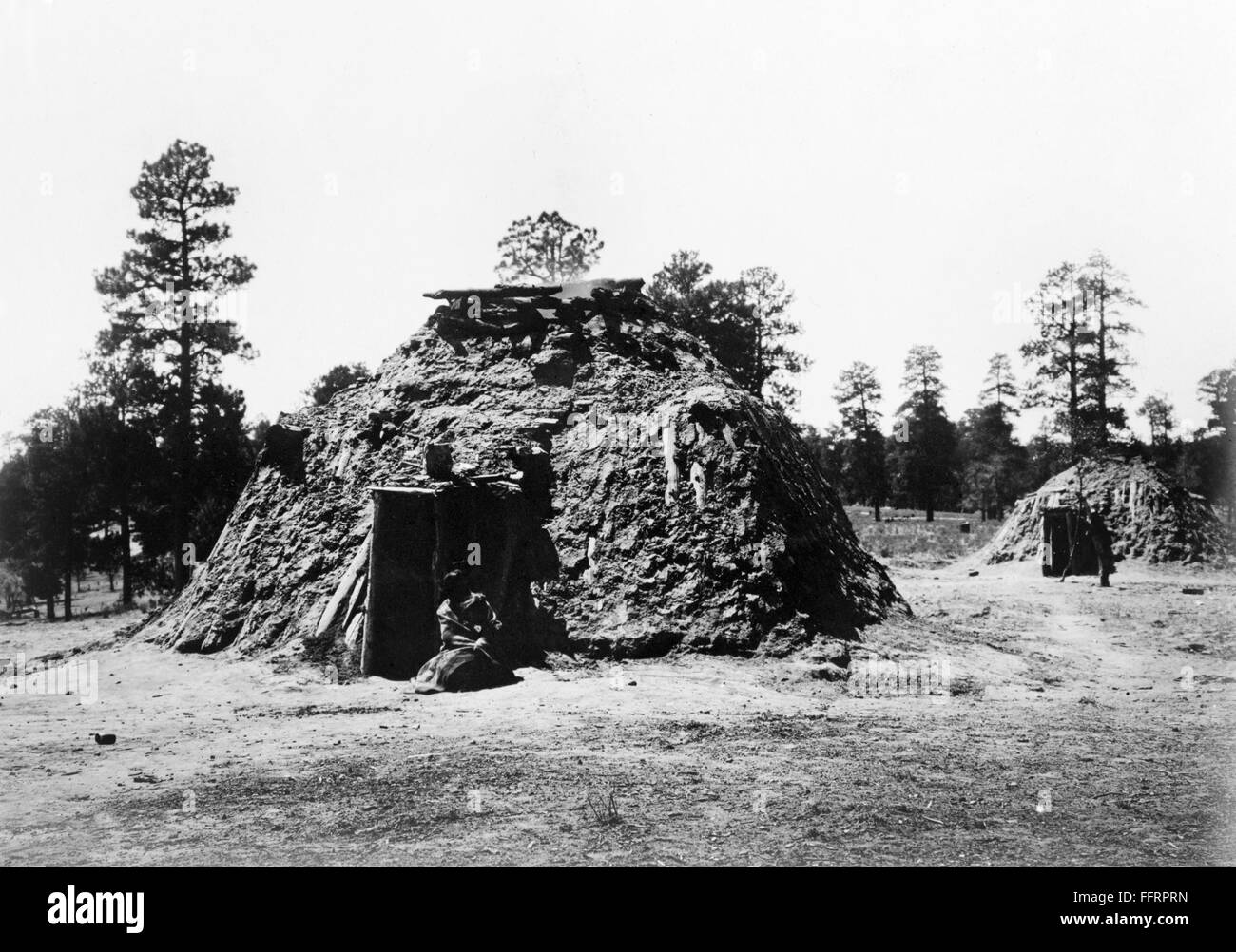 NAVAJO HOGAN, c1905. /nA Navajo woman seated outside a hogan, a ...