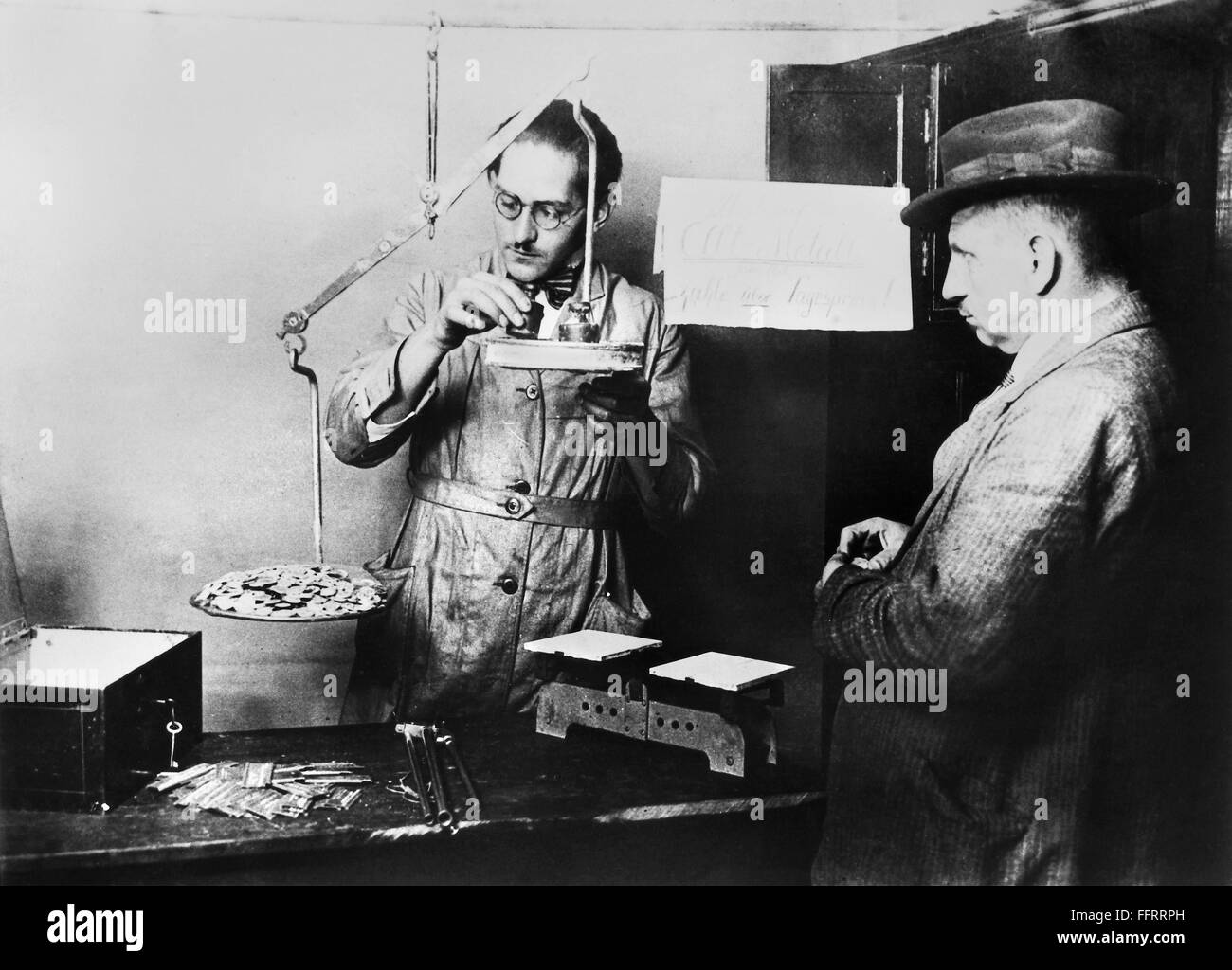 GERMANY: INFLATION, 1923. /nExchanging aluminum 500 mark coins for many ...