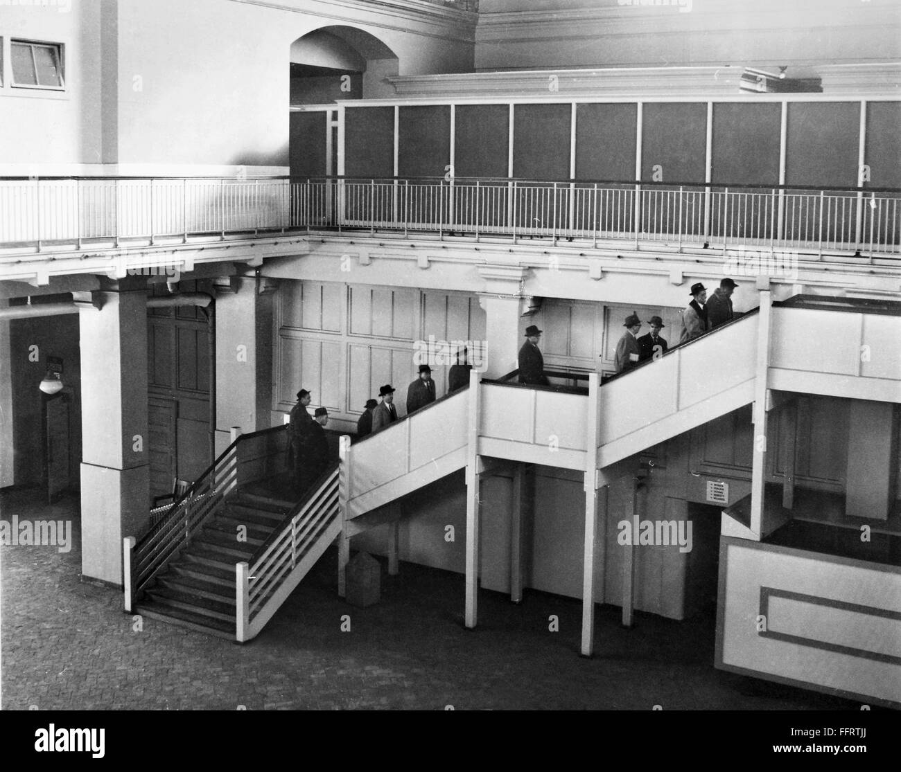 ELLIS ISLAND, 1958. /nProspective buyers of Ellis Island ascending a ...