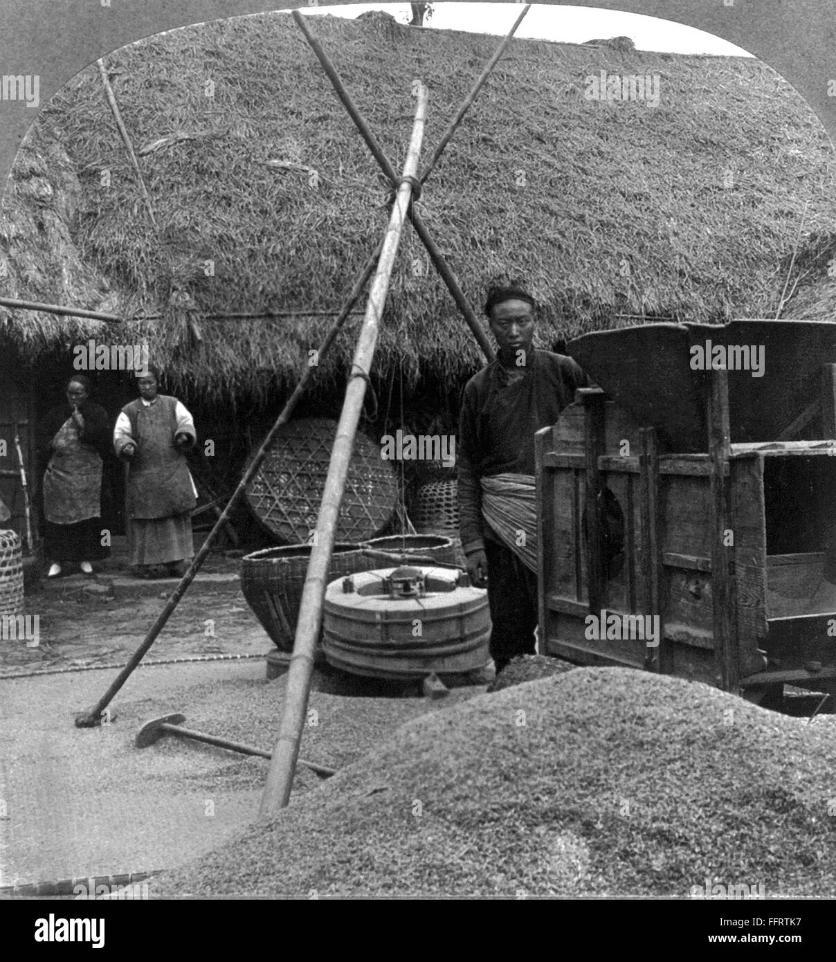 CHINA: MILL, c1908. /nA Chinese man standing next to a threshing ...