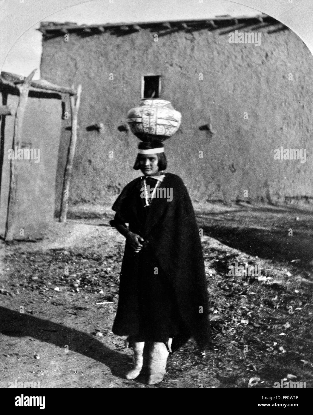 NEW MEXICO: ZUNI GIRL, 1873. /nA Zuni girl carrying a water olla, at a ...