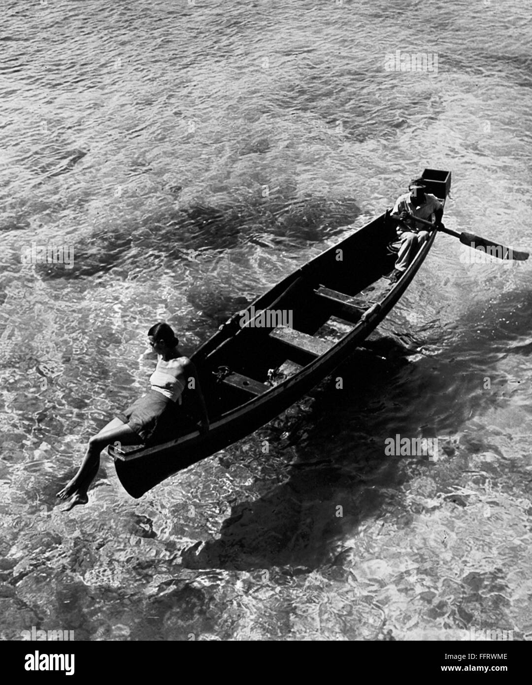 JAMAICA: ROWBOAT, 1946. /nA fashion model sitting on the edge of a ...