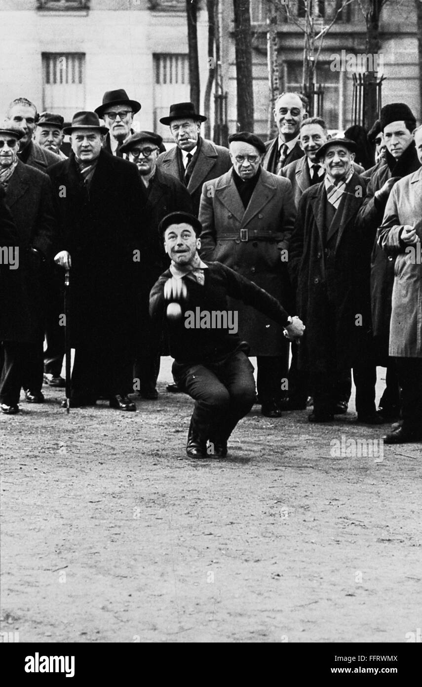 BOCCE PLAYER, c1945. /nA man throwing bocce balls while a crowd watches ...