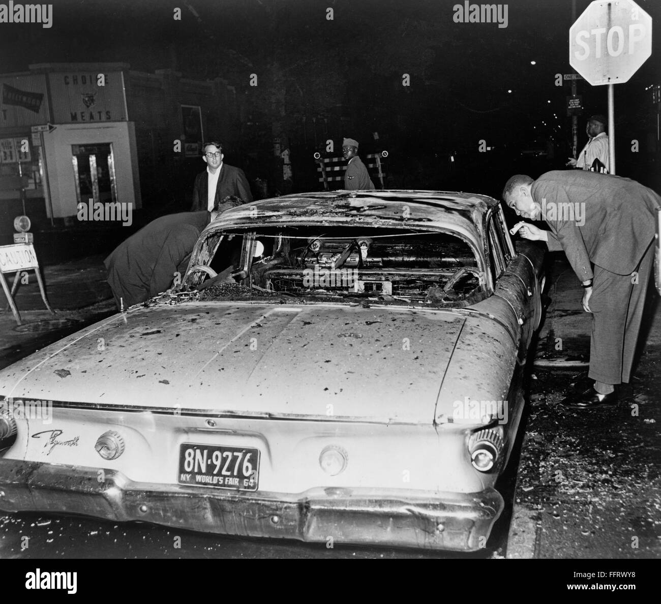 BROOKLYN: RIOTS, 1964. /nDetectives examine a burned out police car on ...
