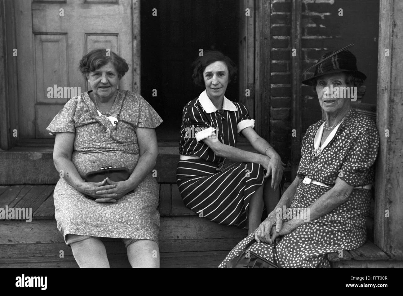 MINNESTOTA: WOMEN, 1939. /nThree women sitting on a stoop of a boarding ...