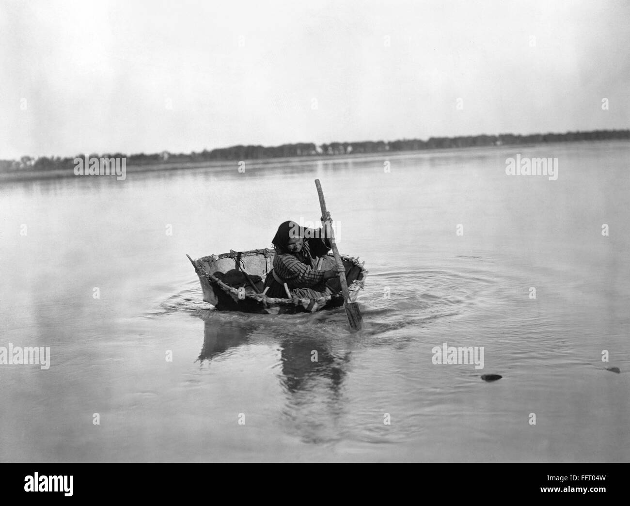 MANDAN BULL BOAT, c1908. /nA Mandan Native American woman paddling a ...