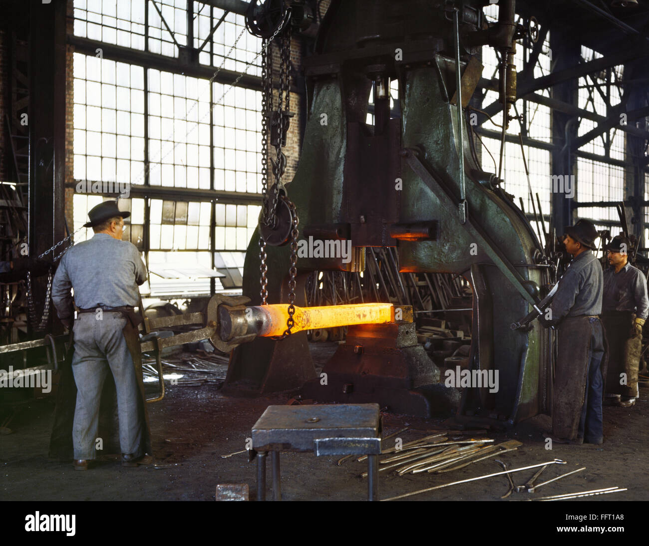 NEW MEXICO: BLACKSMITH. /nThree men hammering out a draw bar on the ...