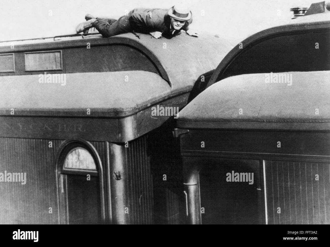 MAN ON RAILROAD CAR, c1907. /nMan lying on top of a railroad passenger ...