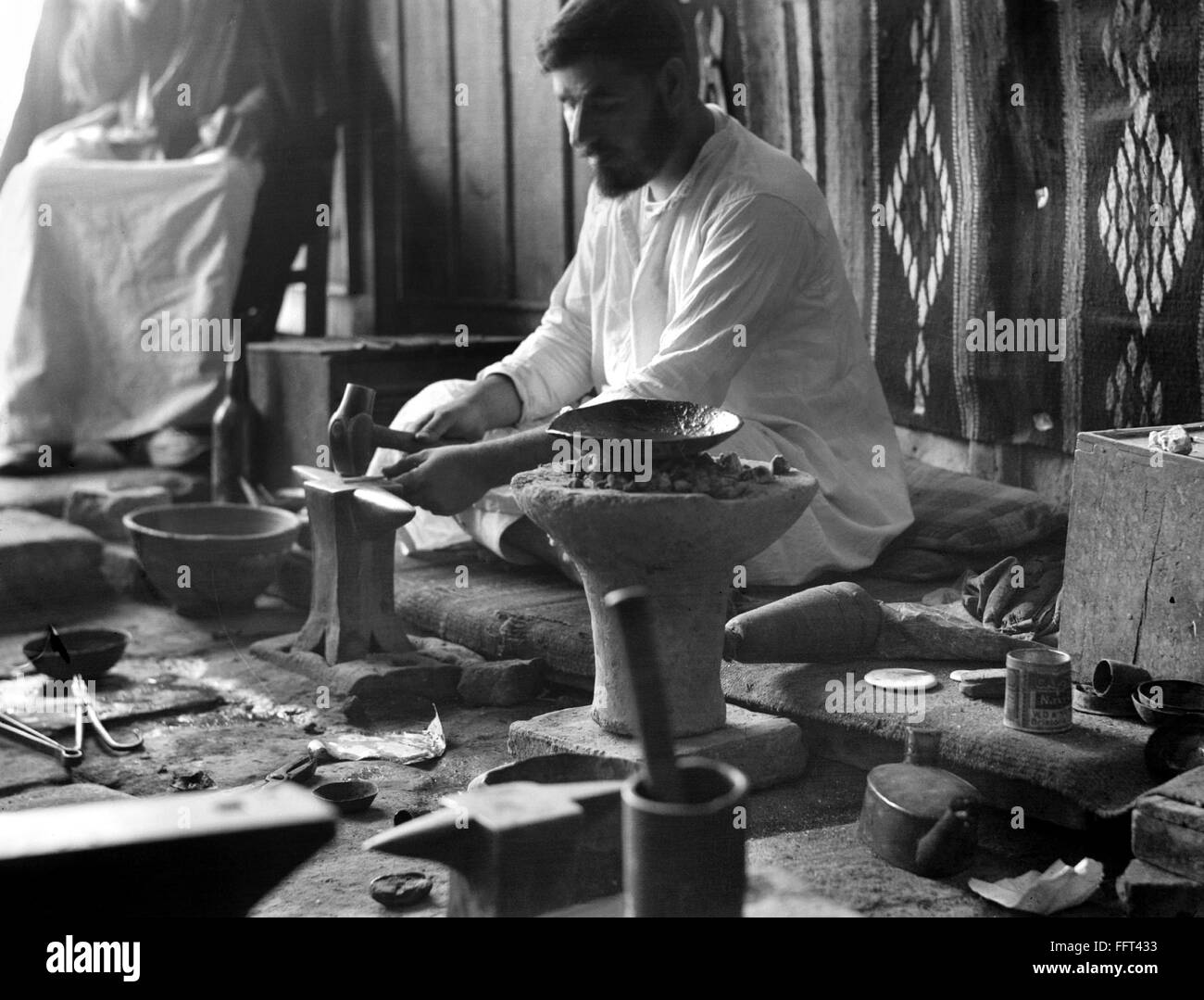 IRAQ: BLACKSMITH, 1932. /nA Iraqi man working as a blacksmith, Iraq ...