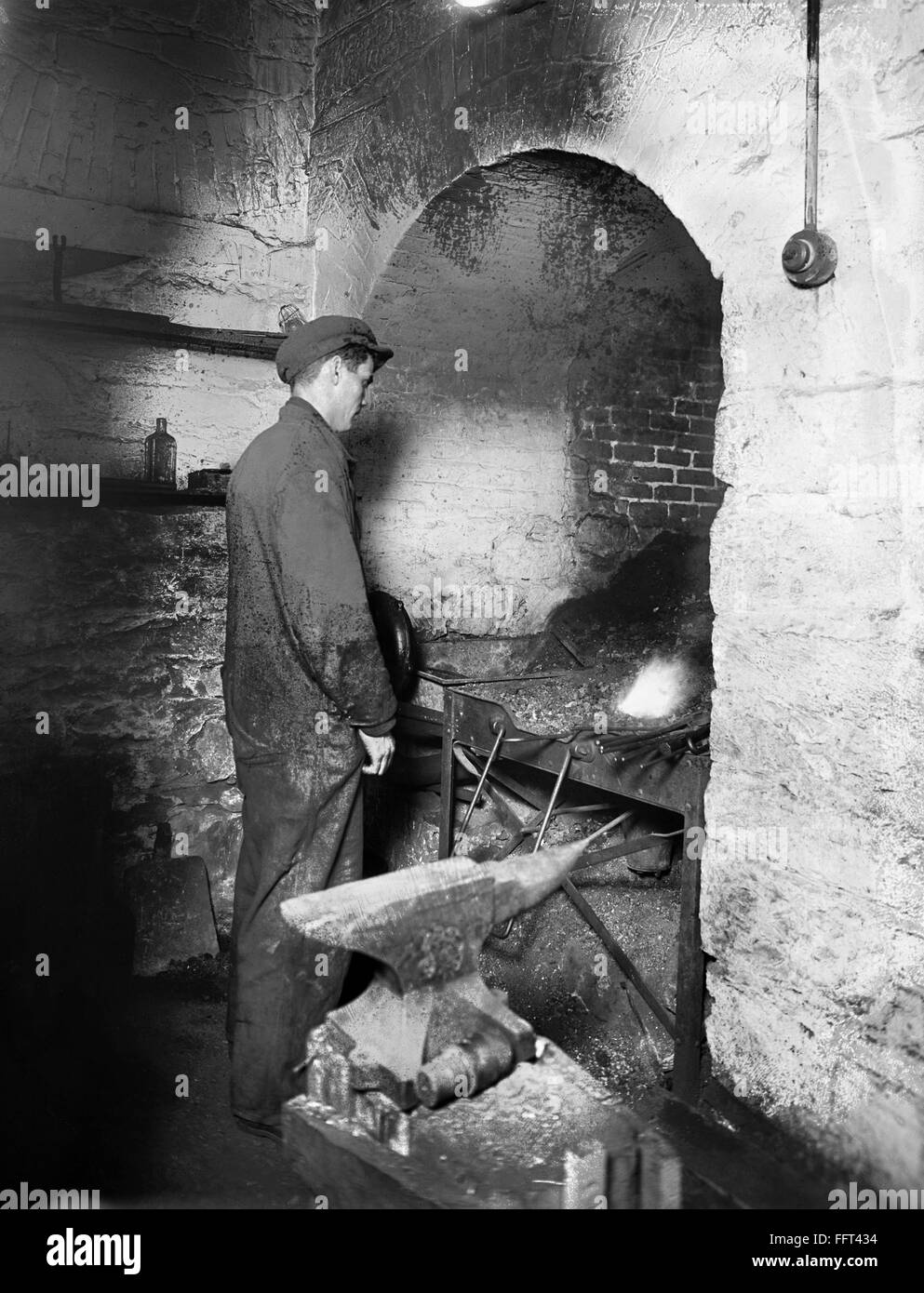 BLACKSMITH, c1920. /nA blacksmith standing at the kiln, Washington, D.C ...