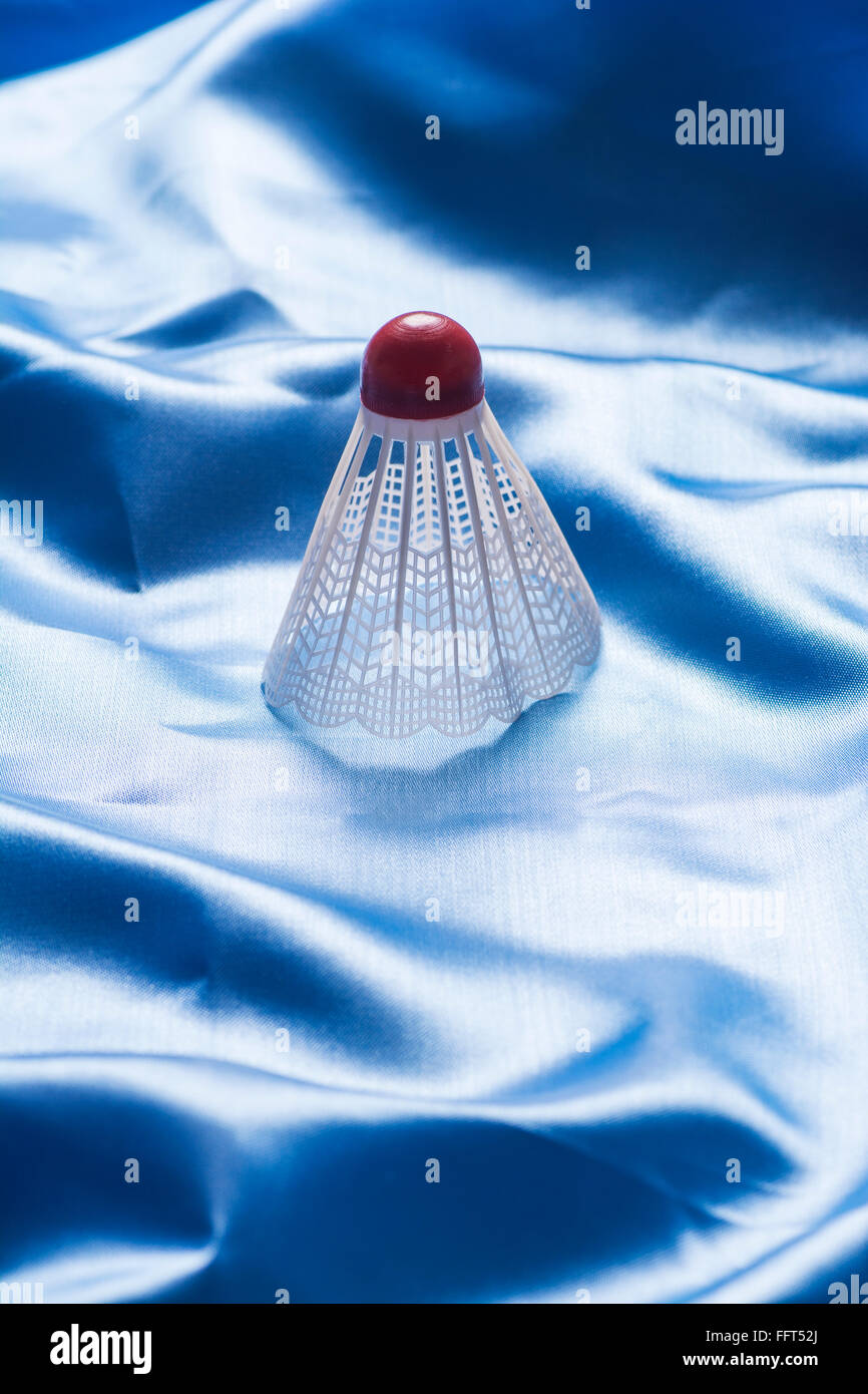 Shuttlecock on blue silk Stock Photo - Alamy
