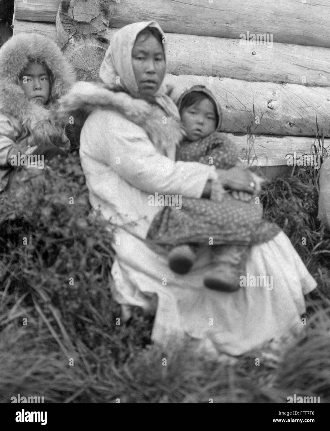 ALASKA: ESKIMOS. /nAn Eskimo woman and three children sitting in the ...