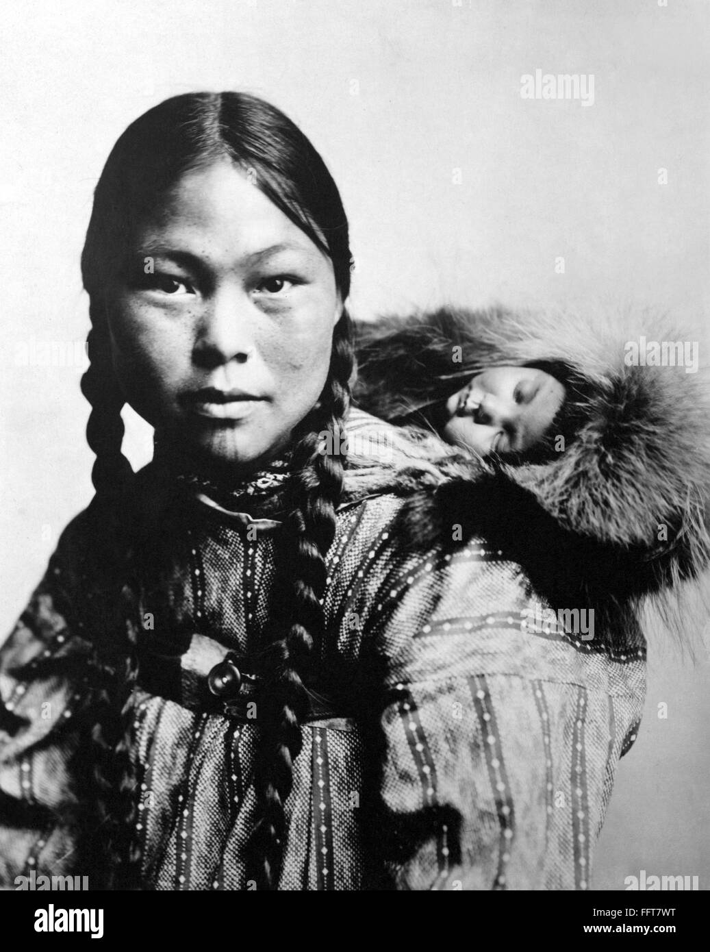 ESKIMO WOMAN AND CHILD. /nEskimo woman with a child on her back, Nome ...