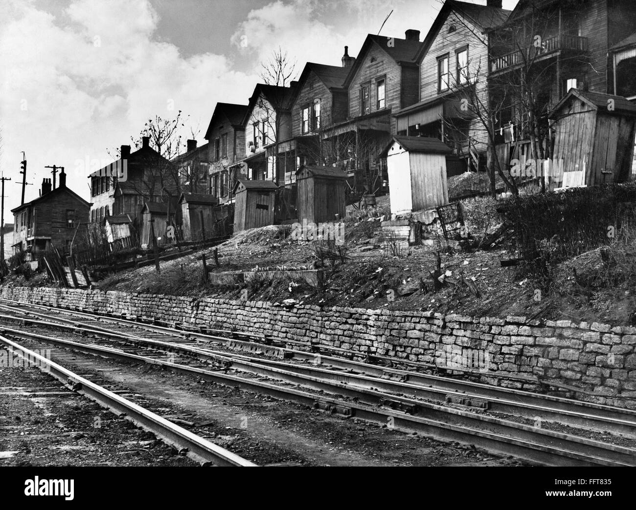 CINCINNATI: HOUSES, 1935. /nA row of low-income houses with outhouses ...