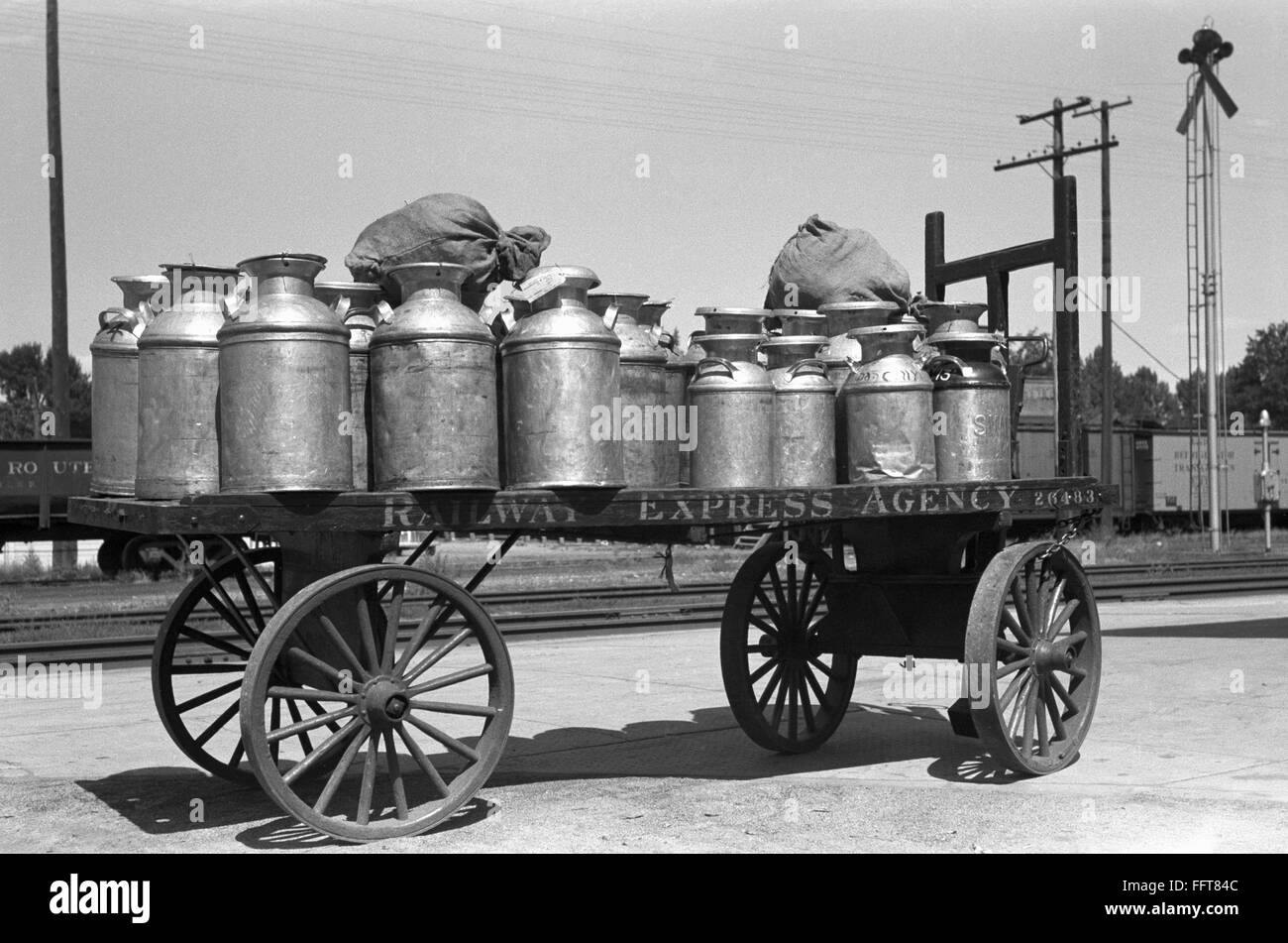 MILK JUGS, 1941. /nRailway cart loaded with containers of milk ...