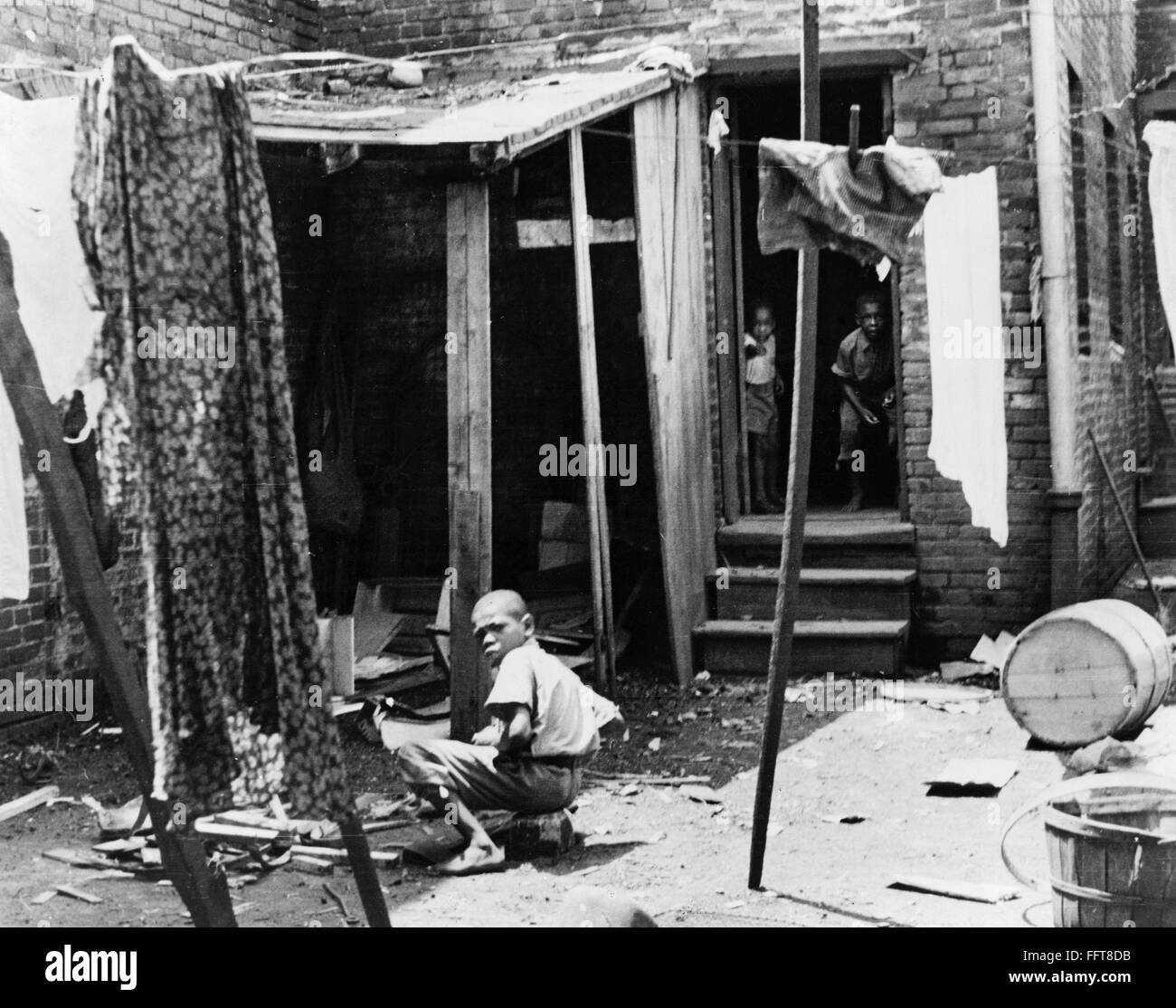 POVERTY: CHILDREN, 1935. /nChildren in their backyard in the slum ...