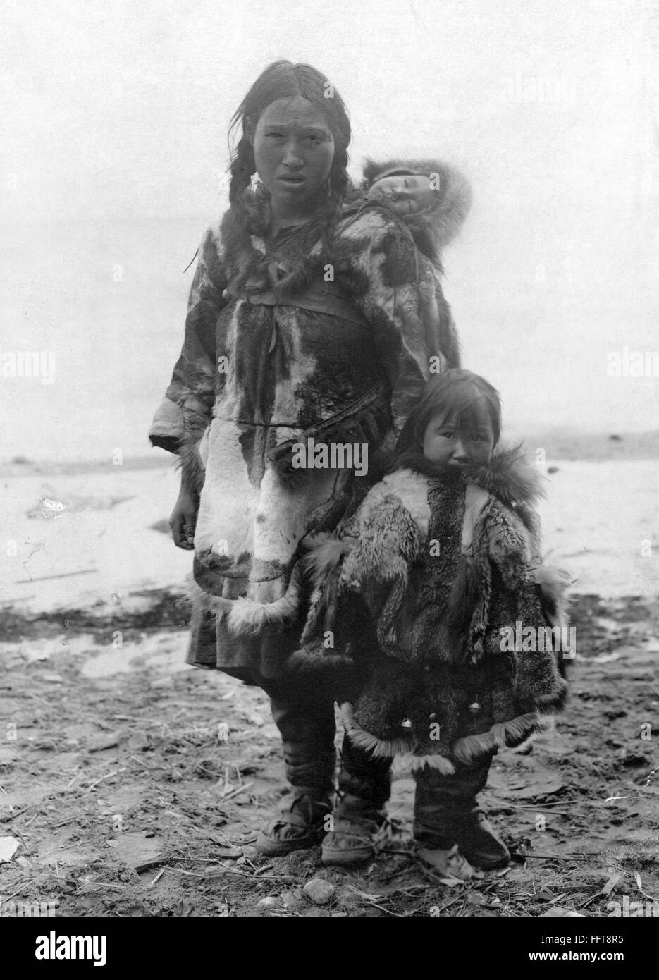 CANADA: ESKIMOS. /nAn Eskimo mother standing outside with her young ...