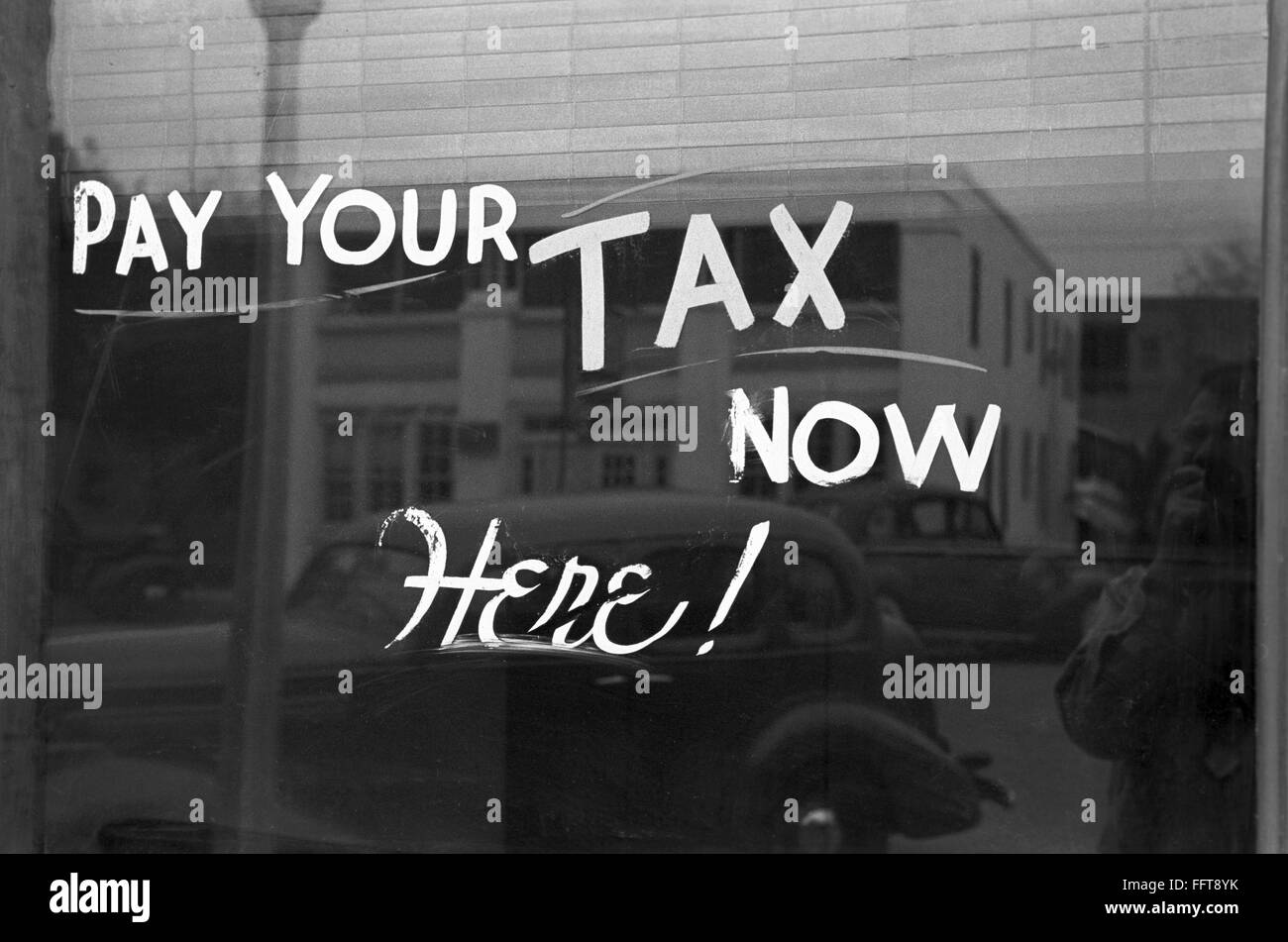 STOREFRONT SIGN, 1939. /n'Pay Your Tax Now, Here!', painted on a ...