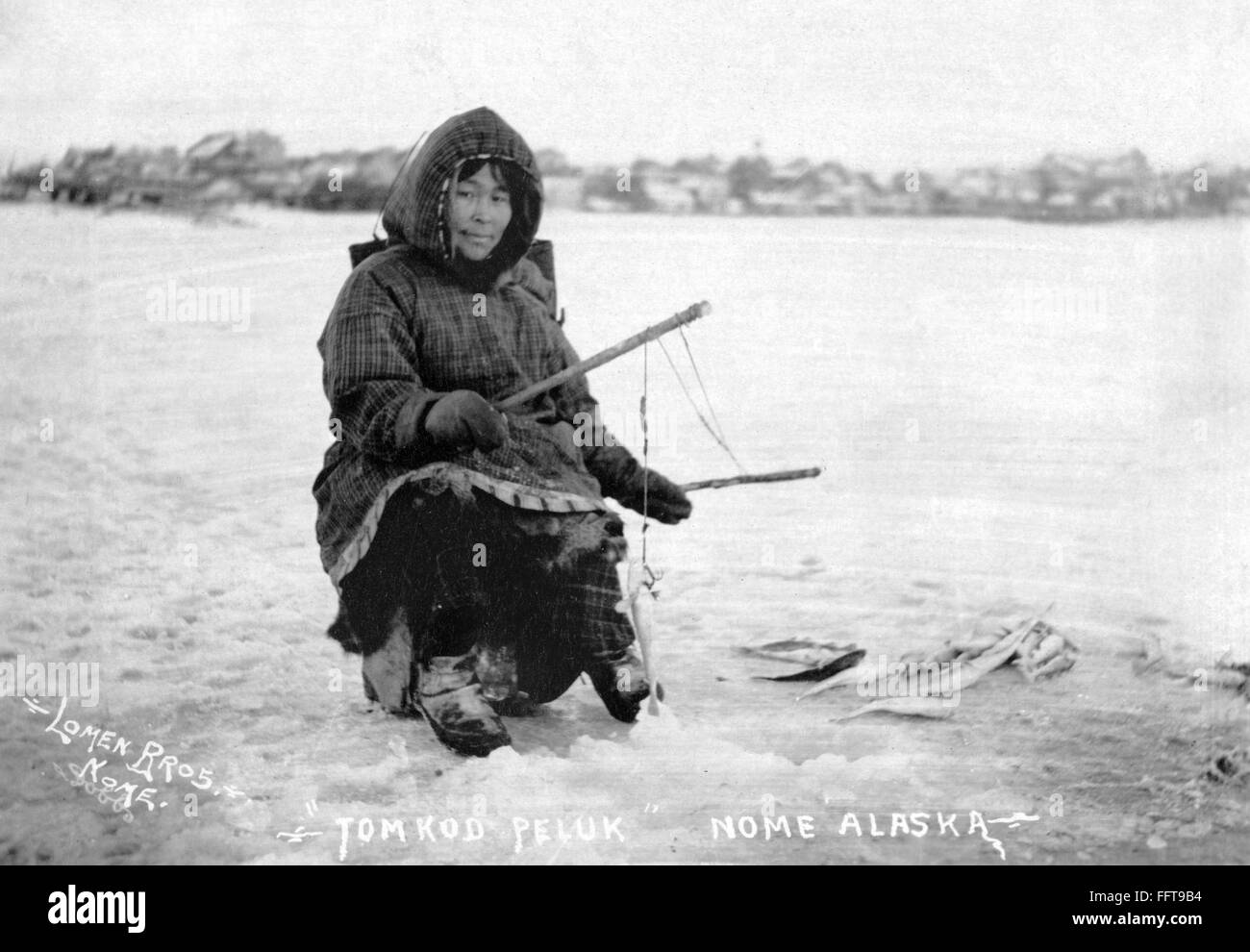 ALASKA: ICE FISHING. /nAn Eskimo man ice fishing in Nome, Alaska ...
