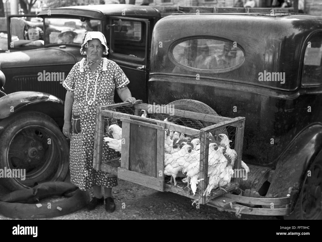 CHICKEN VENDOR, 1939. /nA farm woman selling chickens at a farmer's ...