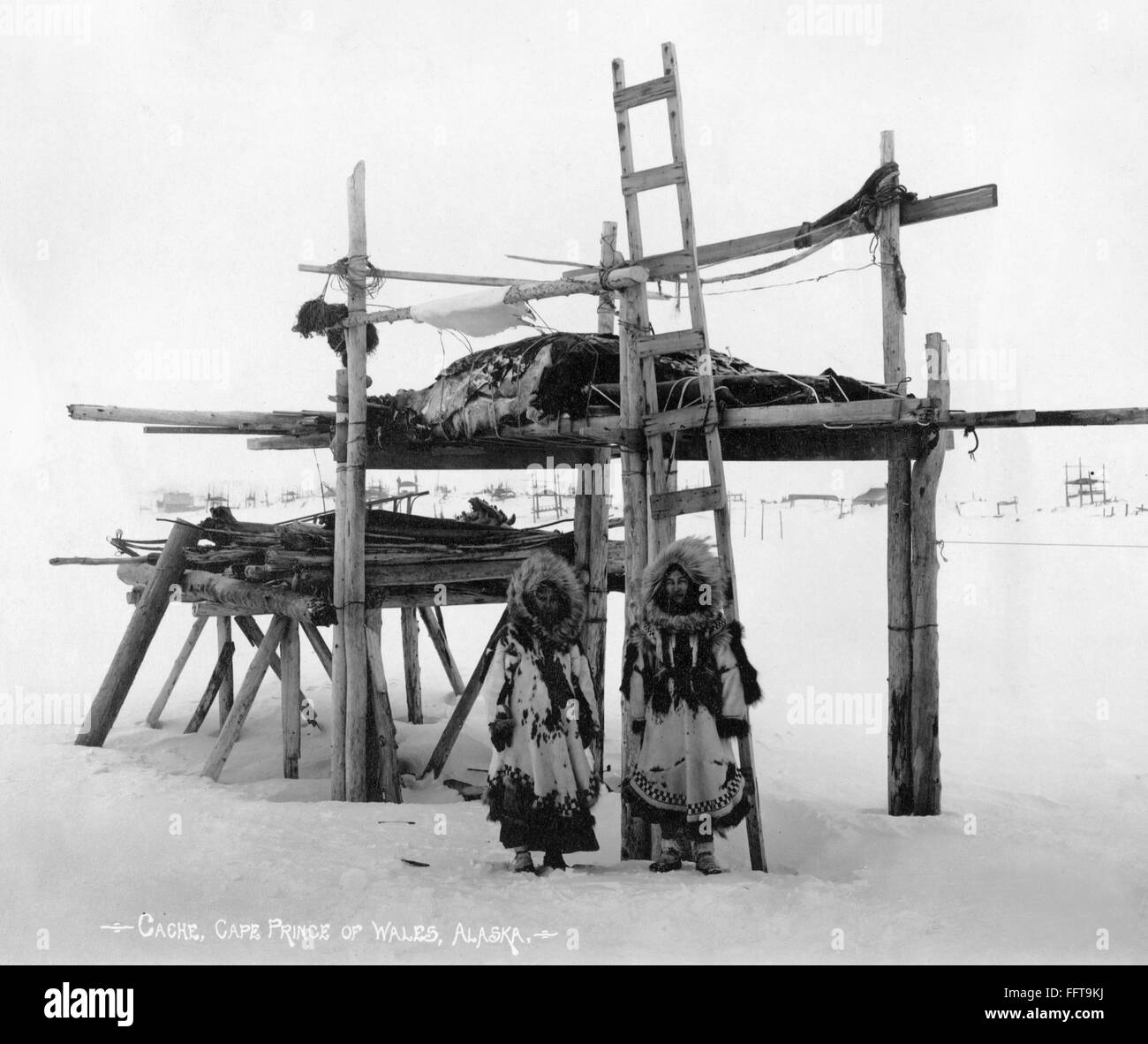 ALASKA: ESKIMO STORAGE. /nTwo Eskimo women standing in front of a ...