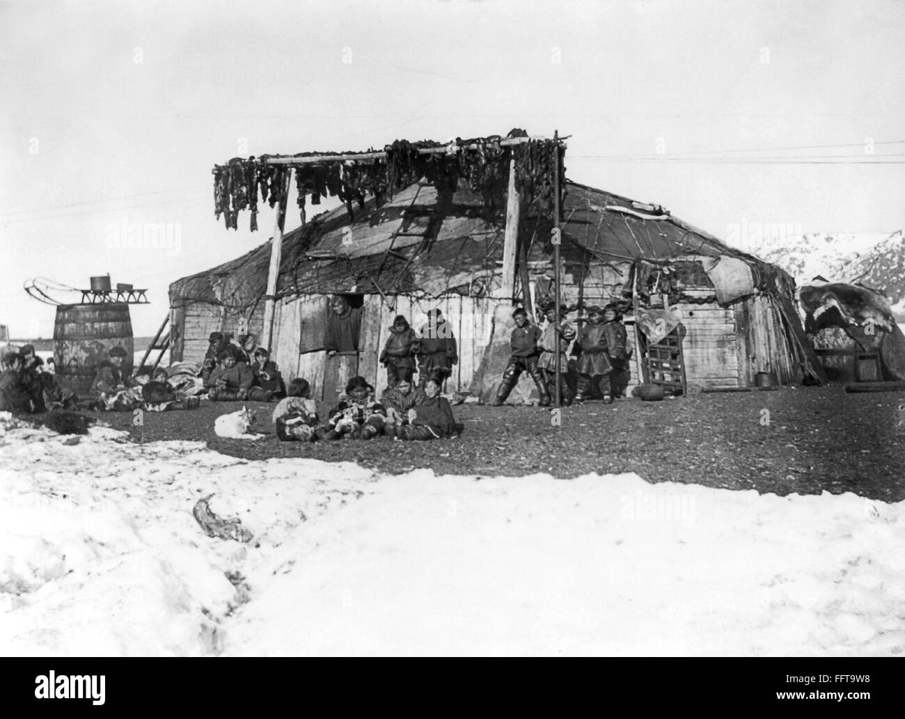 ALASKA: ESKIMOS, c1898. /nA group of Eskimos in front of a large house ...