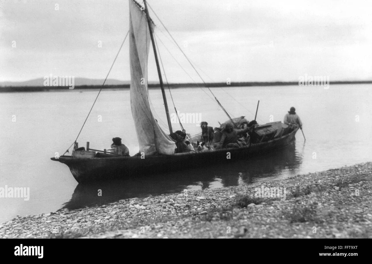 ALASKA: ESKIMO SAILBOAT. /nThree Eskimo men and their dogs in a ...