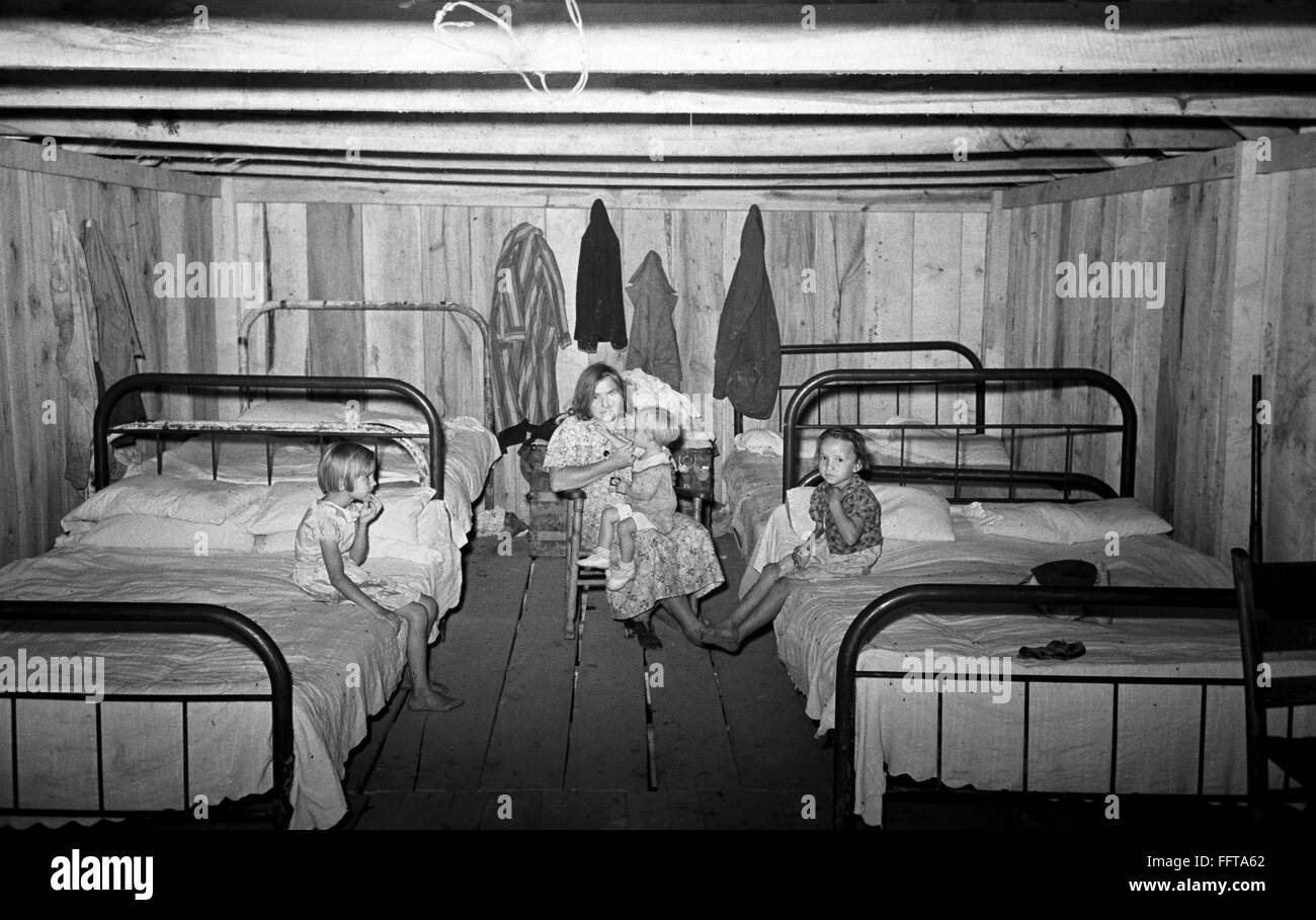 SHARECROPPER HOME, 1938. /nSharecropper's wife with her young children ...