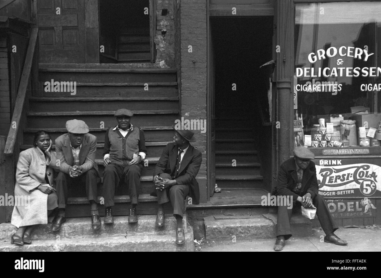 CHICAGO: STOOP, 1941. /nMen and a woman sitting on a stoop in the ...