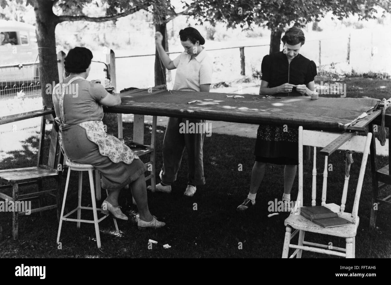UTAH: QUILT MAKING, 1940. /nMormon women tacking a quilt to be used by ...
