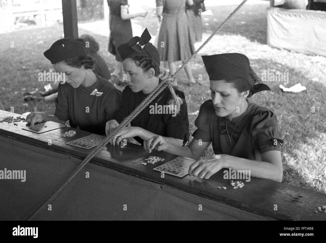BINGO GAME, 1938. /nThree women playing bingo at the Louisiana State ...