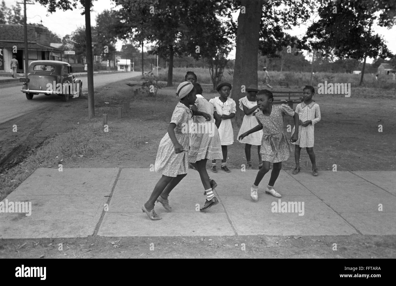 GIRLS PLAYING, 1938. /nA group of African American girls playing on a ...