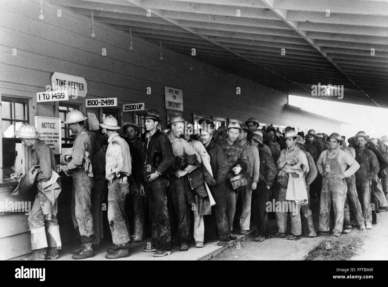 CONSTRUCTION WORKERS, 1940. /nA line of construction workers on payday ...