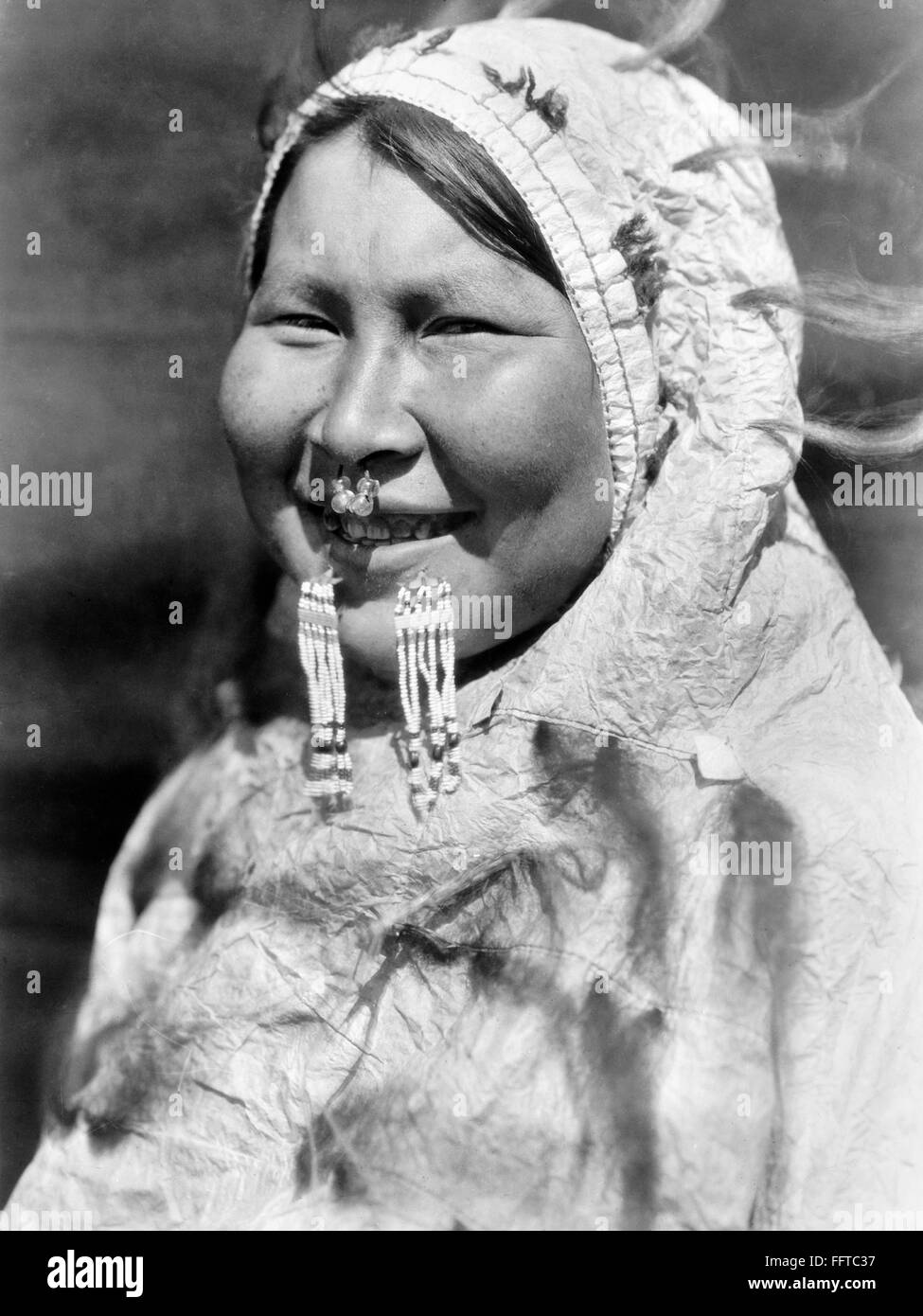 ALASKA: ESKIMO WOMAN./nAn Eskimo woman wearing a nose ring and and a ...