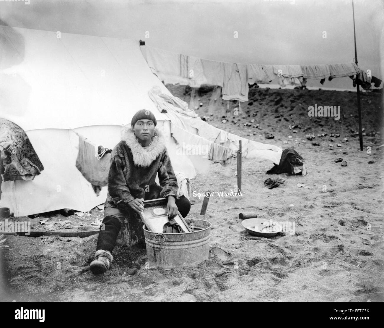ALASKA: ESKIMO, c1906. /nAn Inuit man doing laundry in tub outside his ...