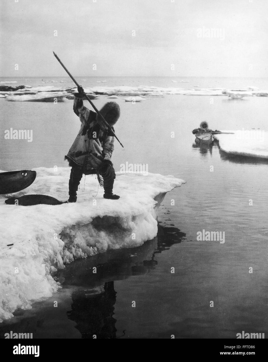ESKIMO FISHERMEN. /nTwo Eskimo fishermen, one poised with a harpoon ...