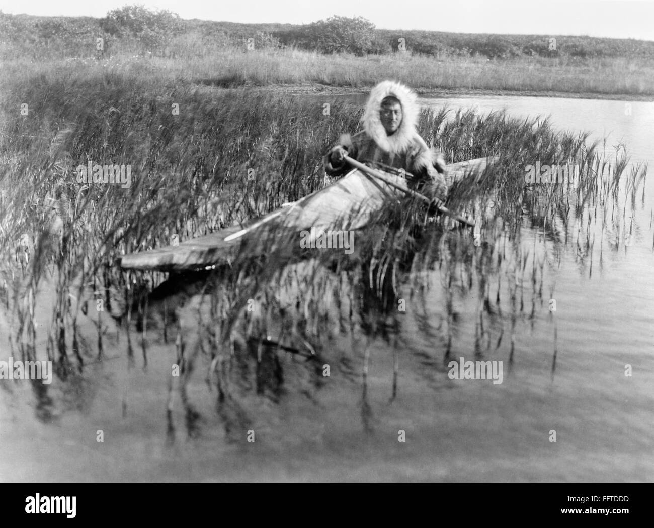 ALASKA: ESKIMO, c1929. /nAn Eskimo muskrat hunter paddling through the ...