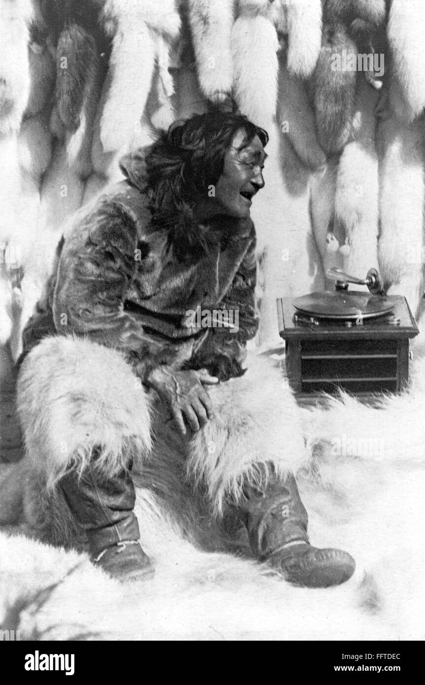 ESKIMO AND PHONOGRAPH. /nAn Eskimo man sitting among furs listening to ...