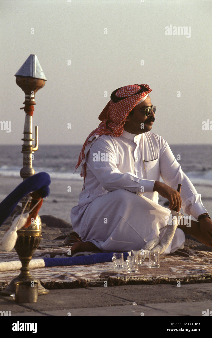 Smoking a water pipe on the beach in the Eastern Province of Saudi ...