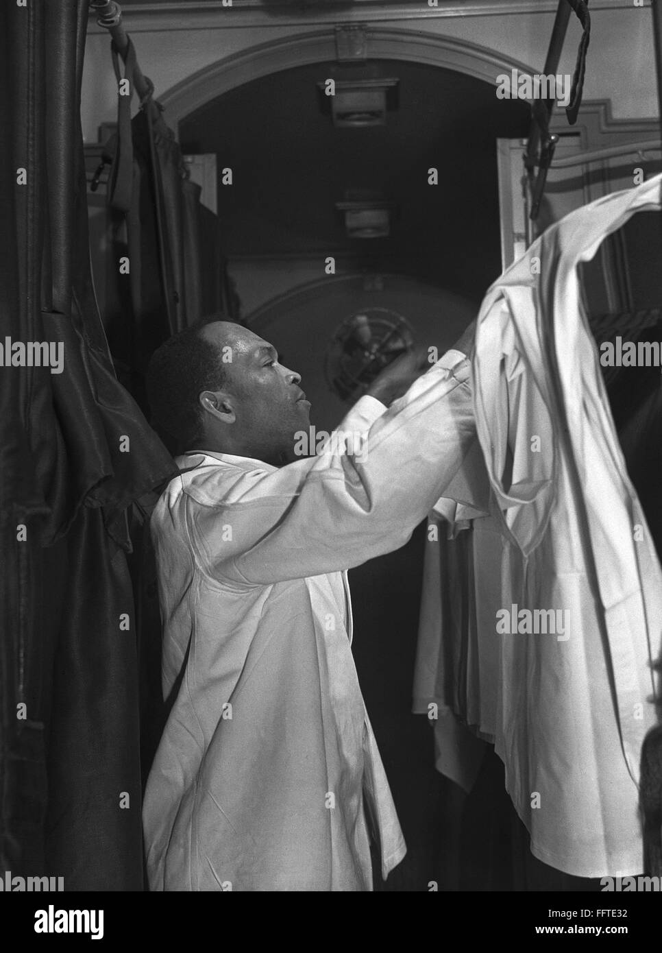 RAILROAD PORTER, 1943. /nPullman porter making up an upper sleeping ...